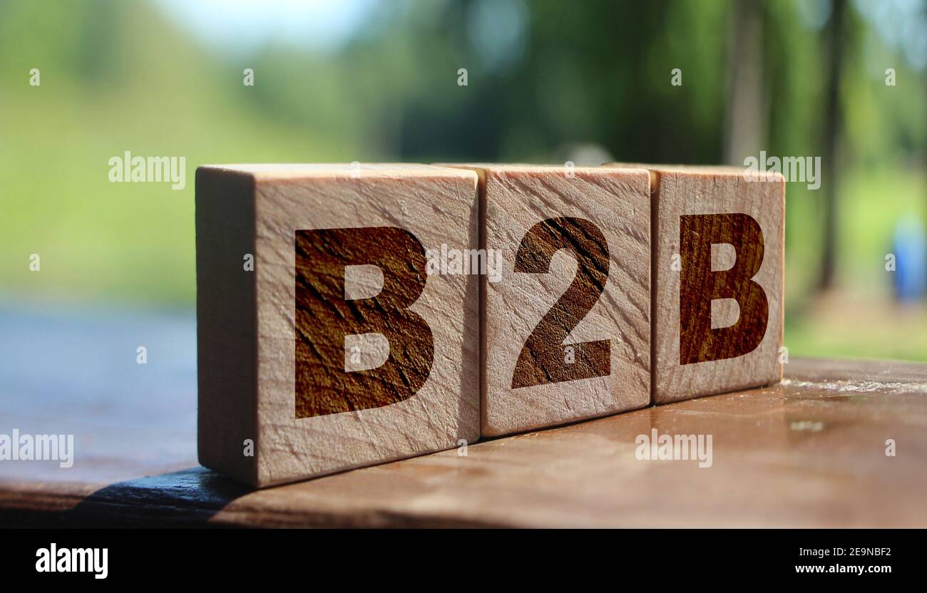 B2C letters on wooden cubes put on wooden table standing outdoors ...