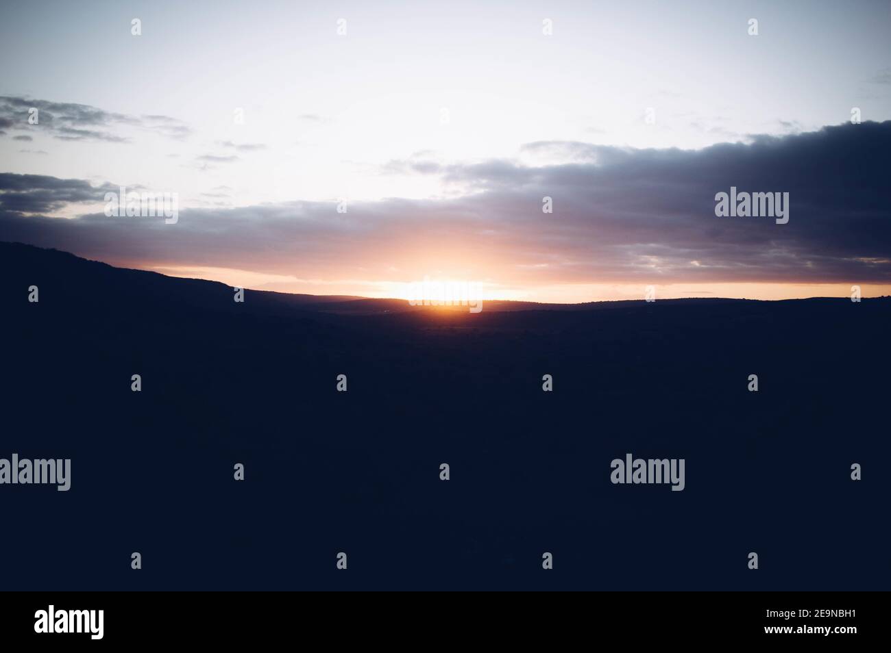 Sun setting down behind silhouette hi-res stock photography and images ...
