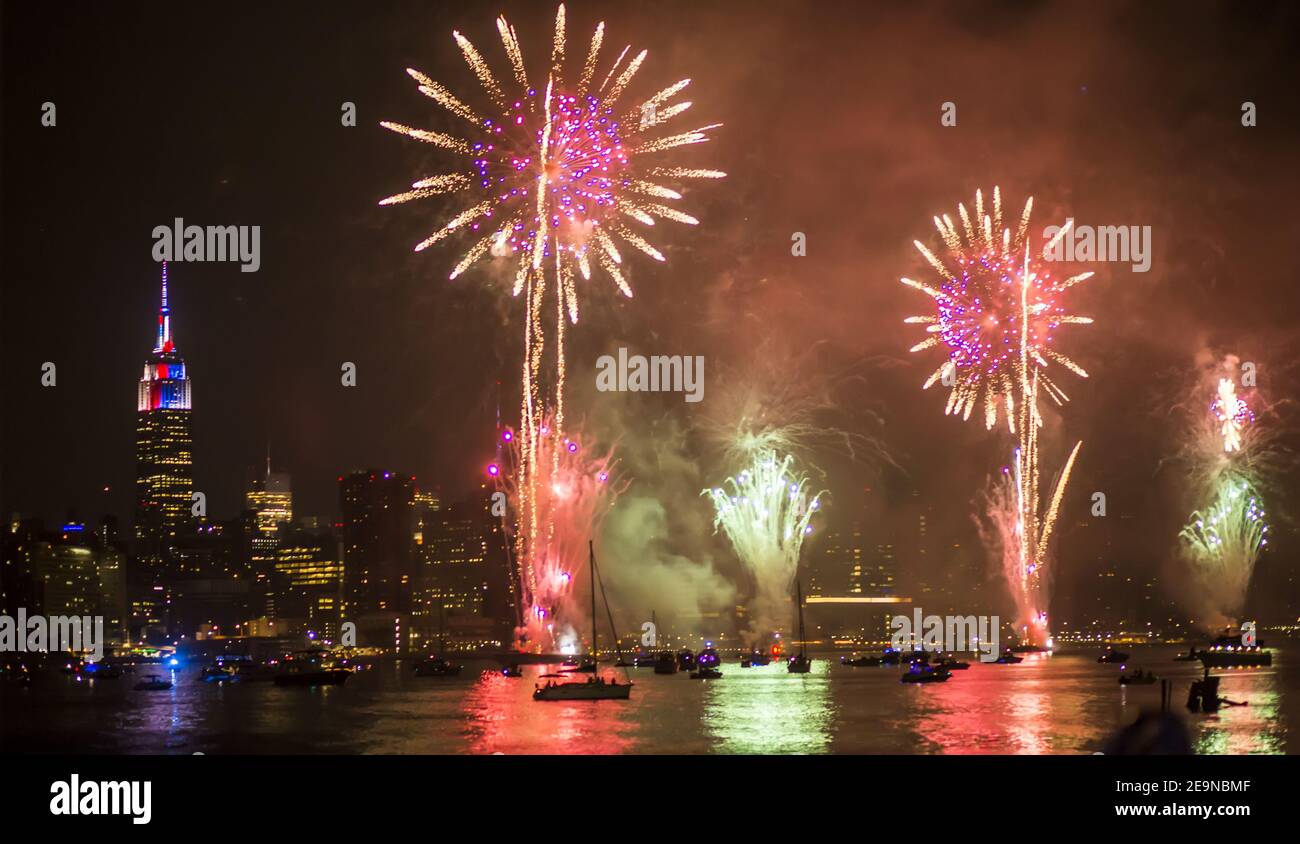 Sun-shaped fireworks in the background of Manhattan night cityscape ...