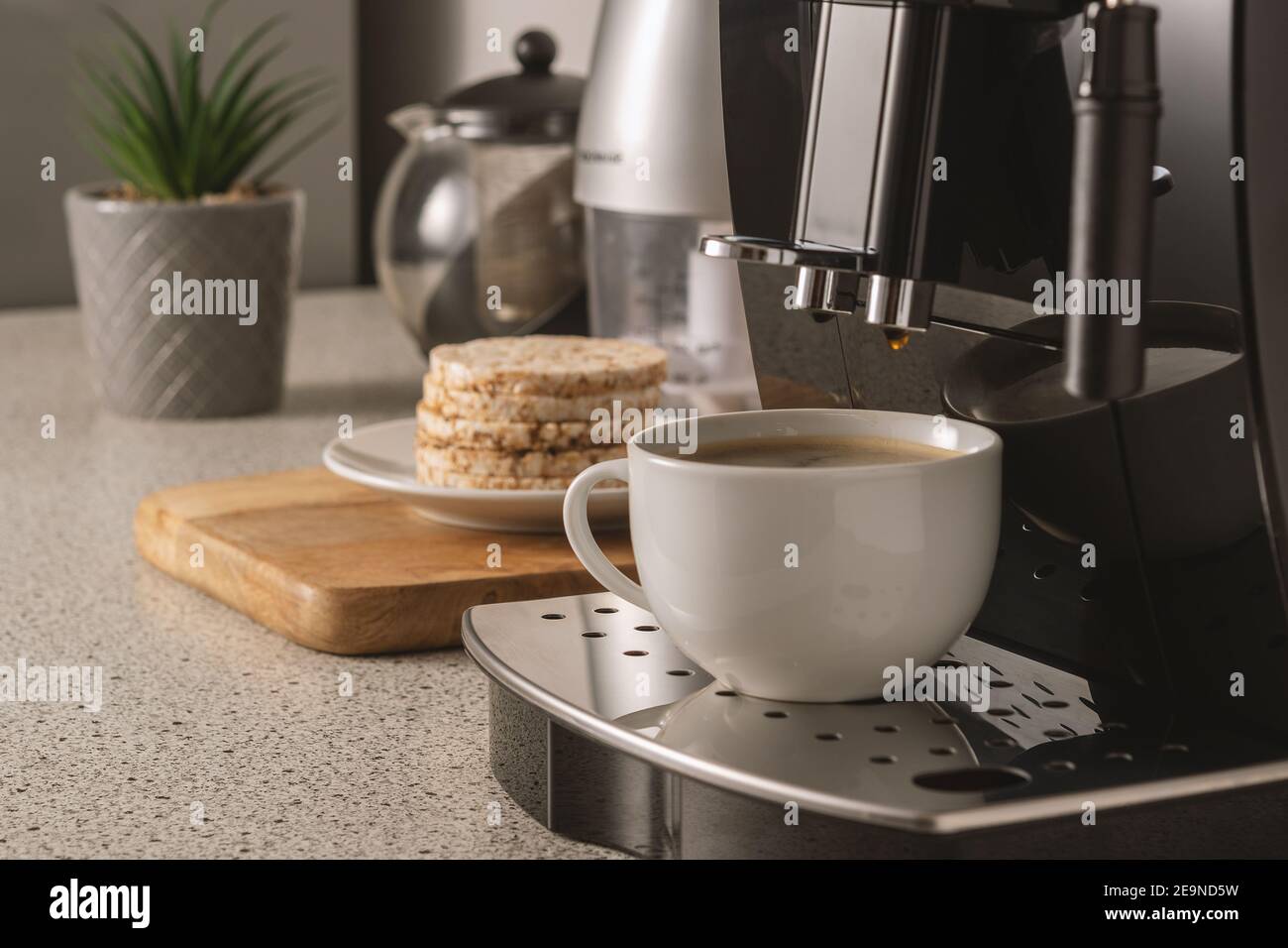 Modern espresso coffee machine with a cup in interior of kitchen ...