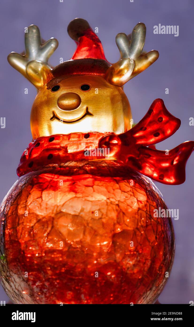 Christmas ornament on a ledge by the window reflecting the afternoon ...