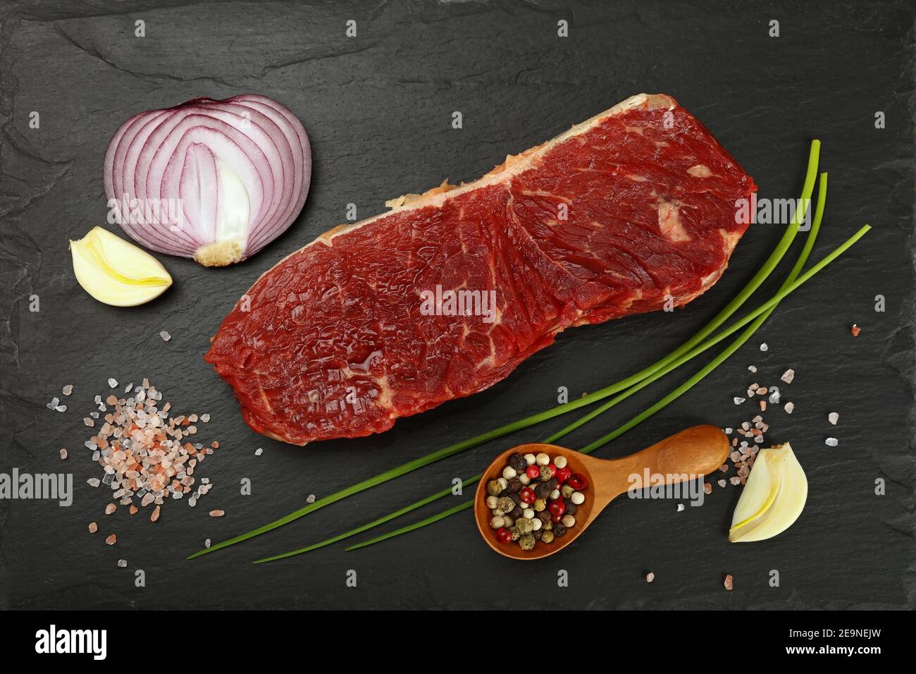 One raw beefsteak red meat cut, spices, peppercorn in wooden scoop ...