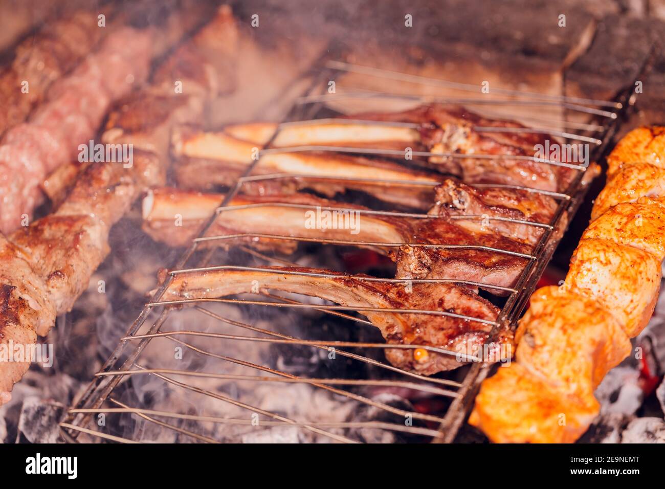 Grilled kebab cooking on metal skewer. Roasted meat cooked at barbecue ...