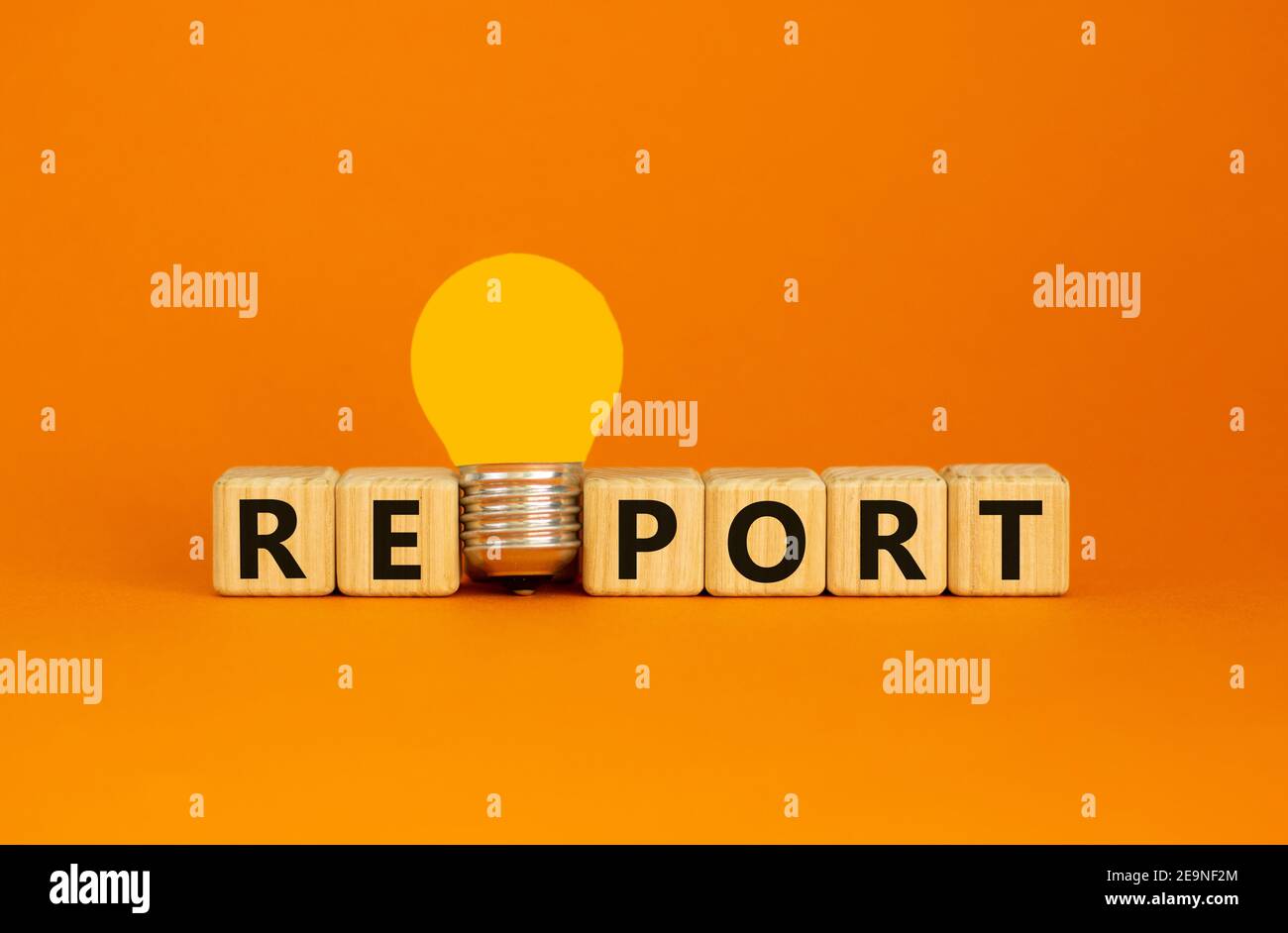 Report symbol. Wooden cubes with word 'report'. Yellow light bulb ...