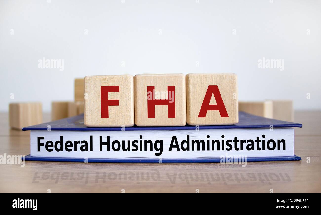 FHA symbol. Wooden blocks and book with words 'FHA federal housing ...