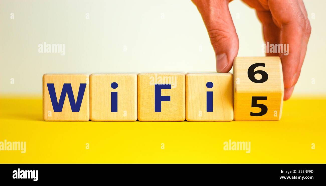 WiFi 5 or 6 symbol. Businessman turns a wooden cube and changes the ...