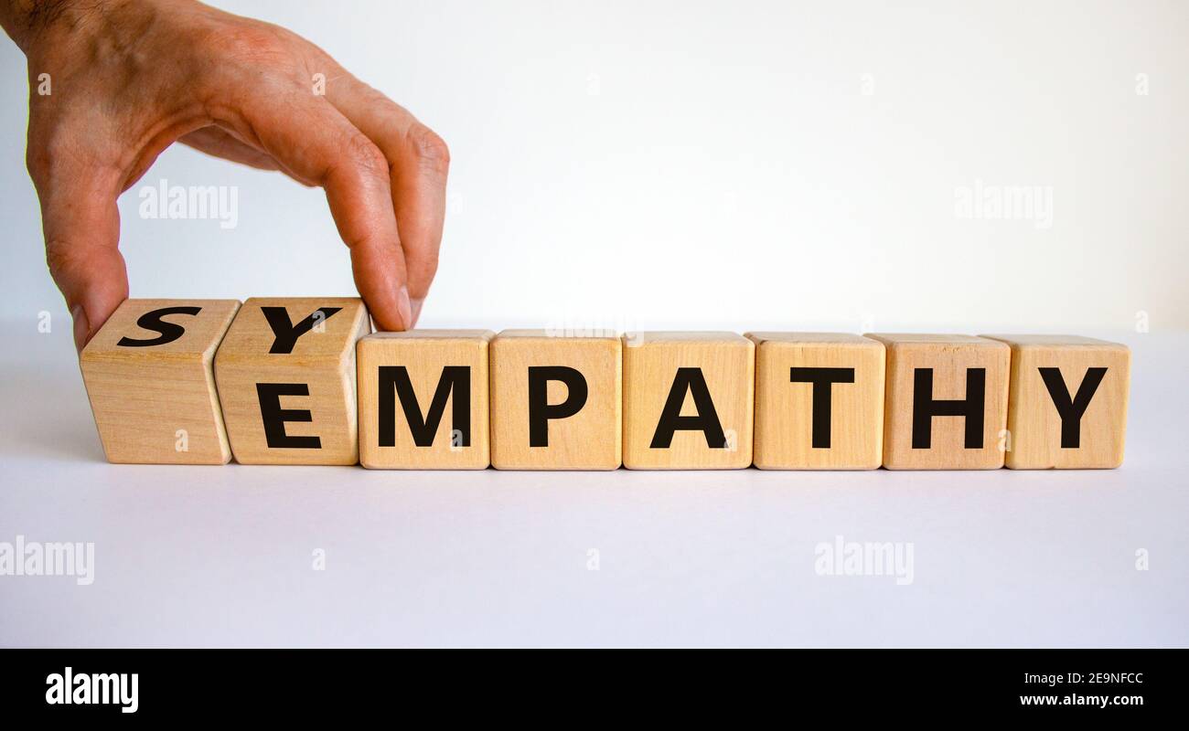Sympathy or empathy symbol. Businessman turns wooden cubes and changes ...