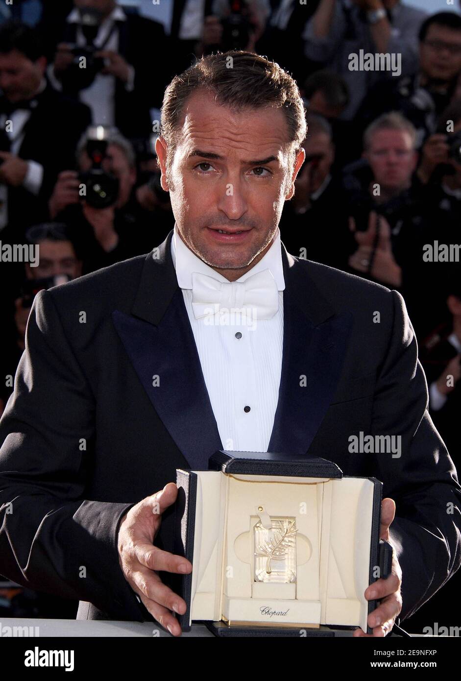 French actor Jean Dujardin poses with his award for Best Performance by ...