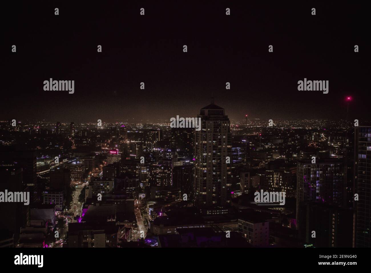 Aerial view of an urban neighborhood with illuminated modern high-rise ...