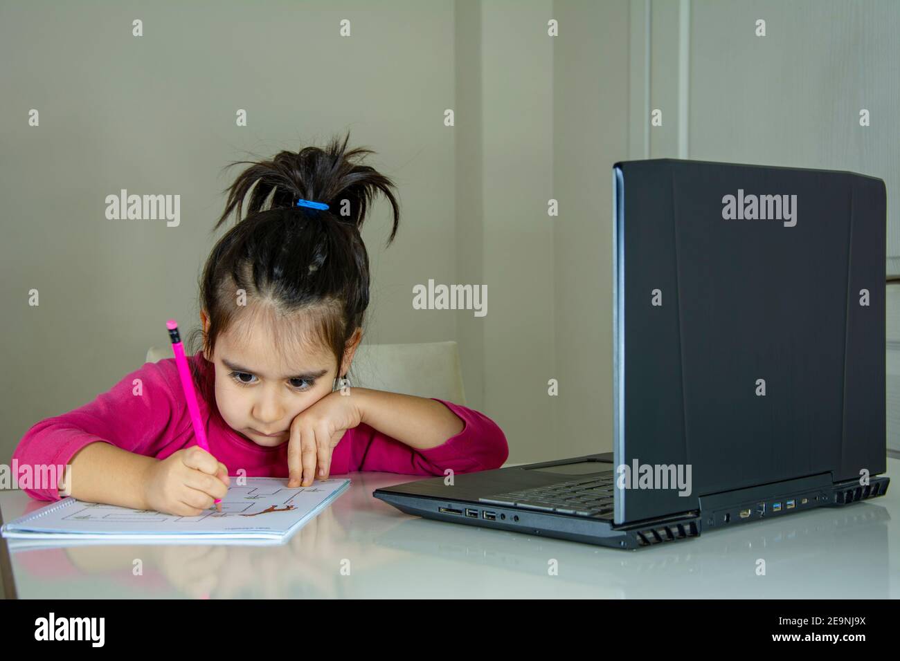Little girl doing her study in online education Stock Photo - Alamy