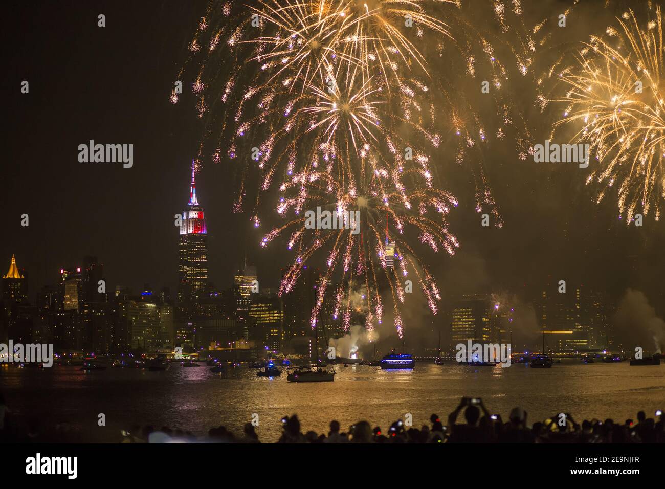Manhattan skyline and bright brocade type fireworks in the night sky ...