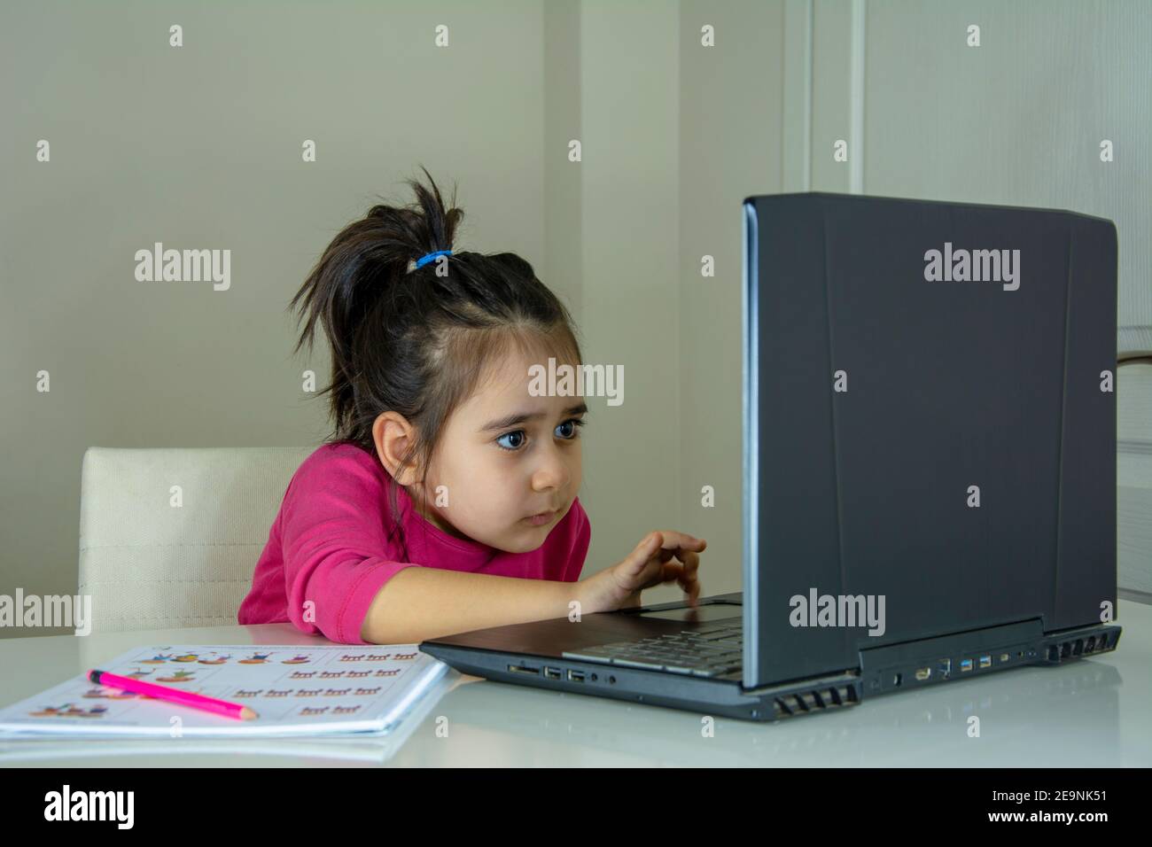 Little girl using computer hi-res stock photography and images - Alamy