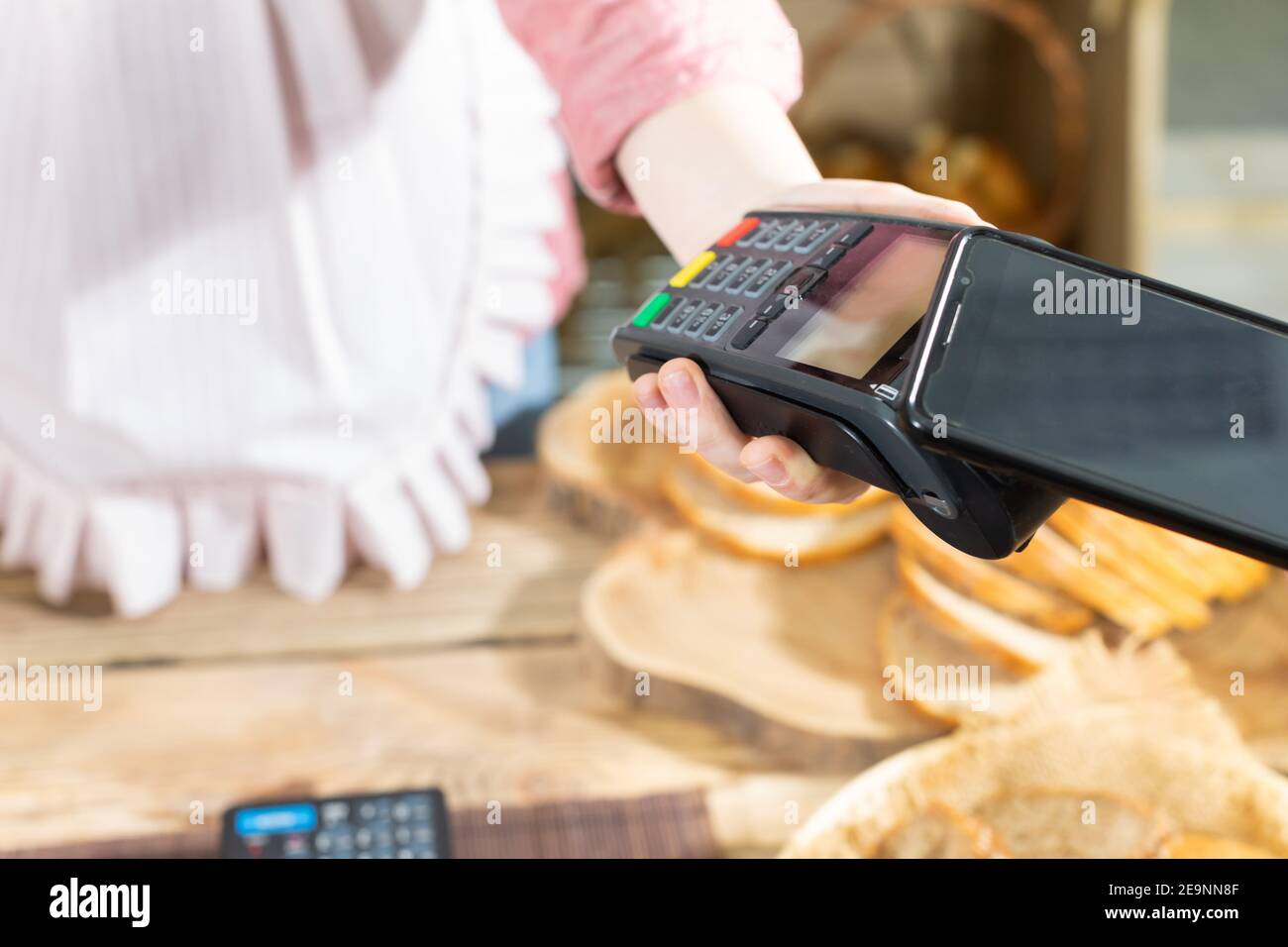 The client pays for the purchased bread through the payment terminal ...