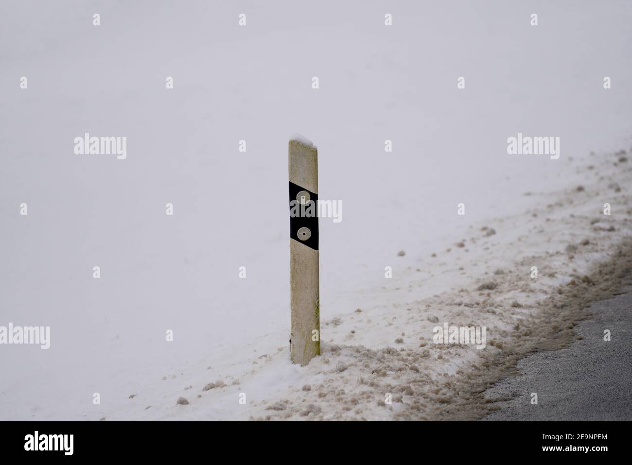 Wooden warning sign on the side of the road covered with snow Stock ...