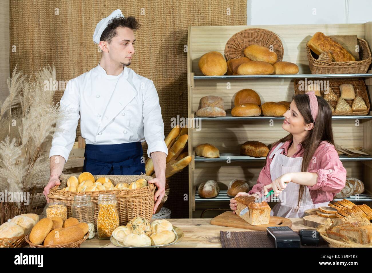 A new clerk learns to cut the bread properly under the baker's ...