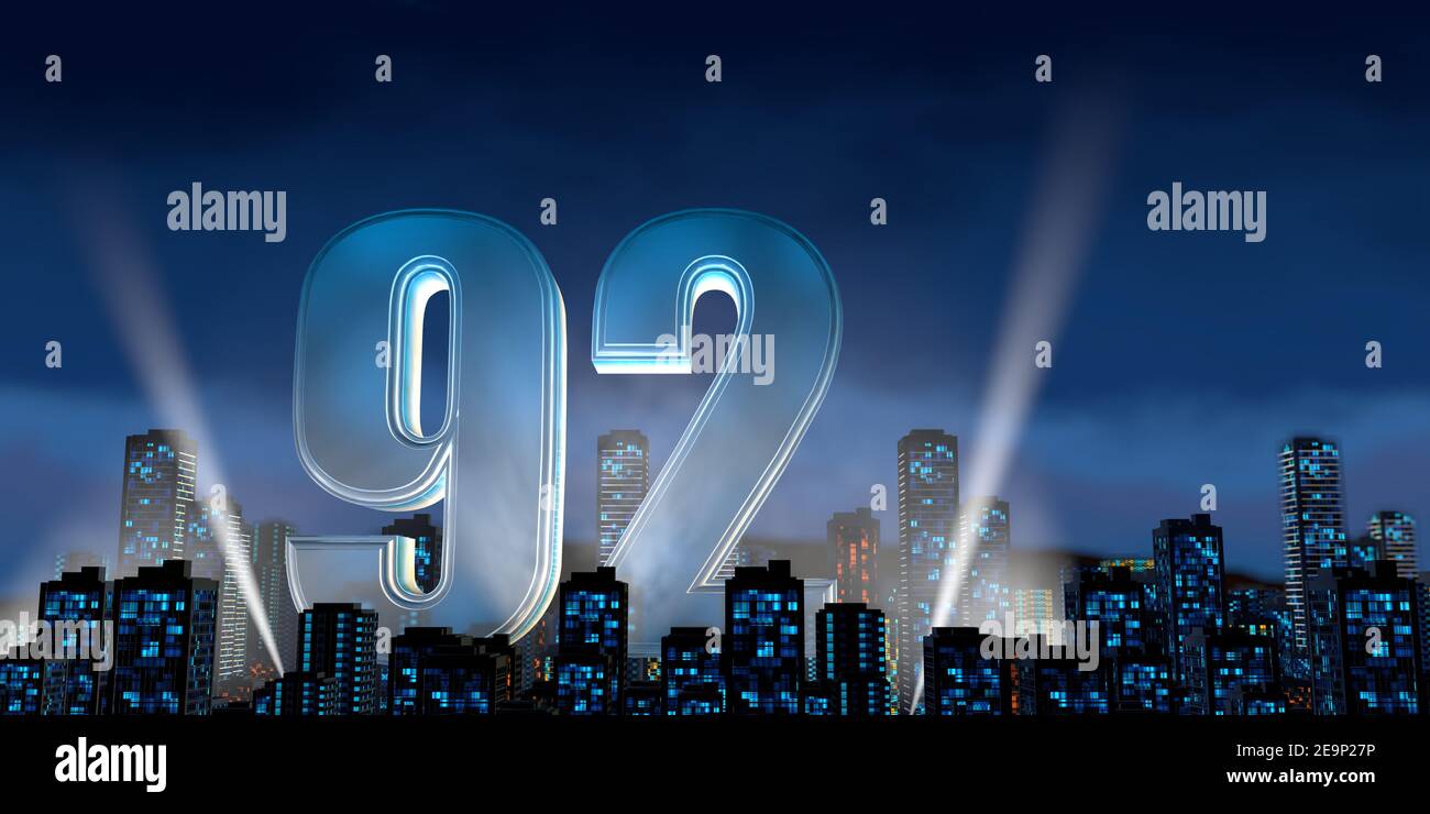 Number 92 in thick blue font lit from below with white light reflectors ...