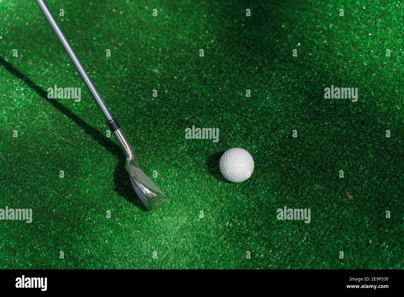 Golf sport game with niblick and white ball on the green grass. Playing ...