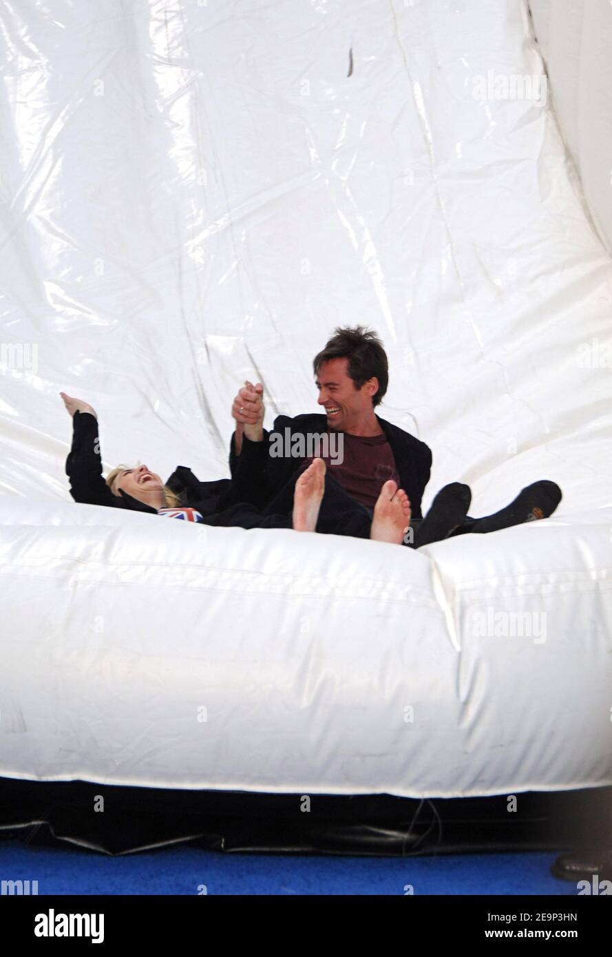 Actors Kate Winslet and Hugh Jackman slide down a 30-foot inflatable ...