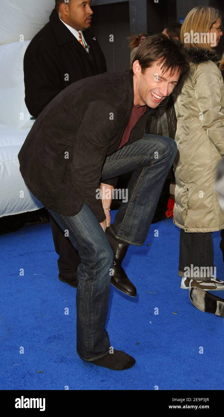 Actor Hugh Jackman puts his shoes on after sliding down a giant 'toilet ...