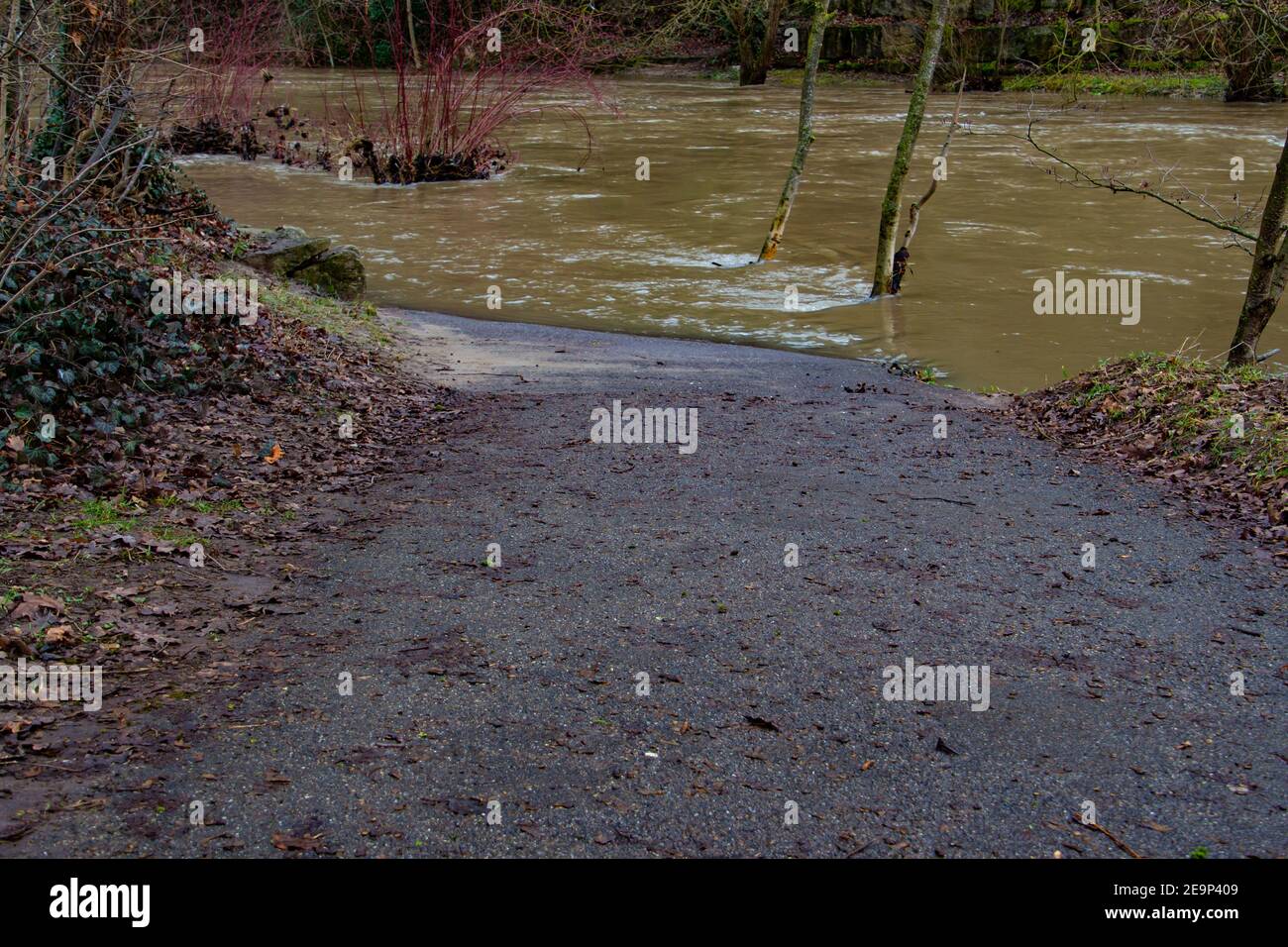Pedestrian walkway leading into the floods of a river Stock Photo - Alamy