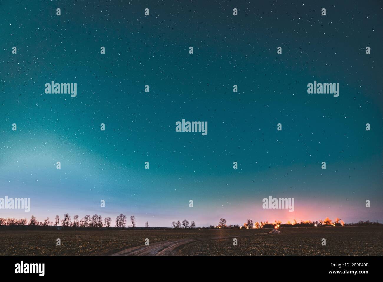 Night Starry Sky With Glowing Stars Above Country Road In Early Spring ...
