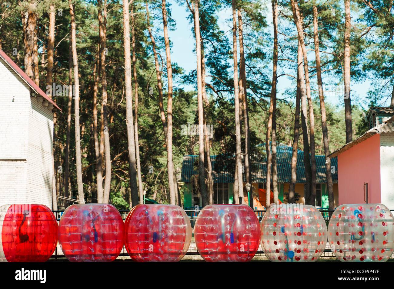 Bubble ball balloons on the green field. equipment for team building ...