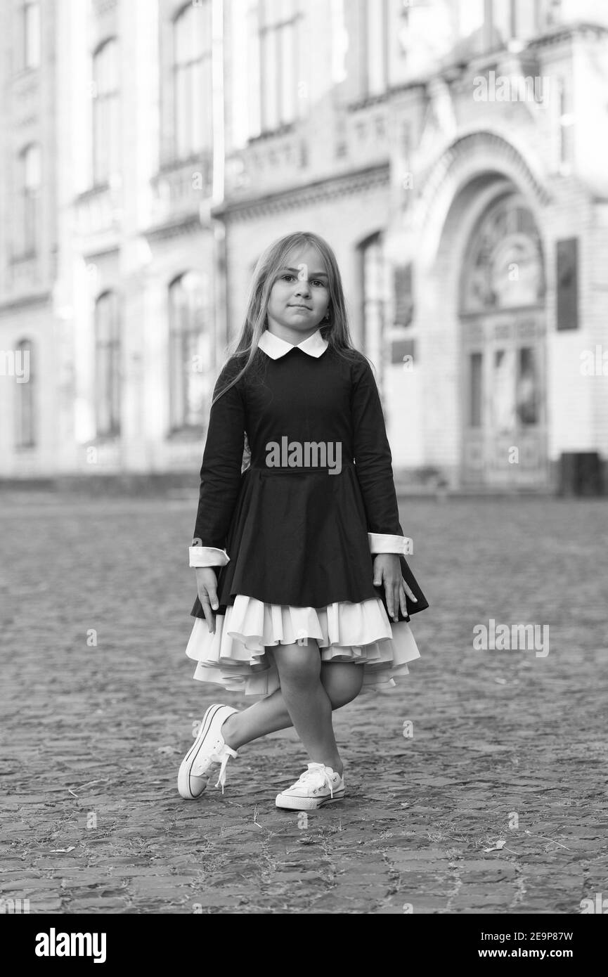 Practice makes perfect. Little kid make curtsy outdoors. Small ...