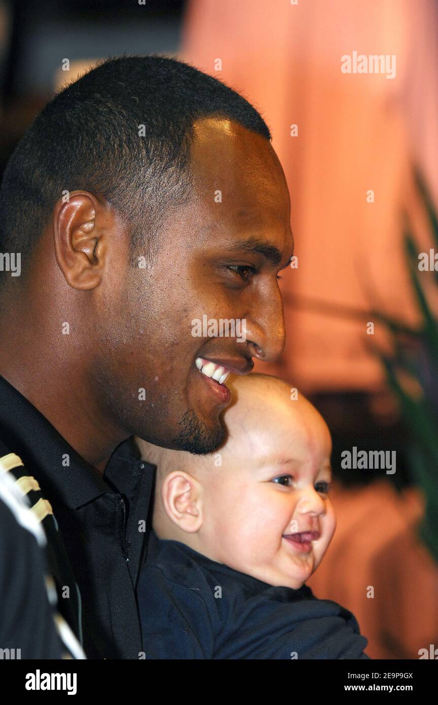 All Blacks' rugbyman Josevata Rokocoko poses with a baby fan at Adidas ...
