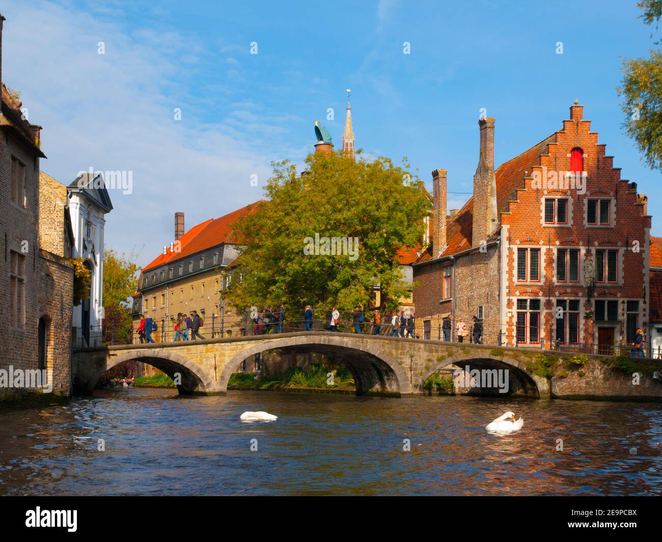 Water canal with old bridge and medieval houses of Bruges, Belgium ...