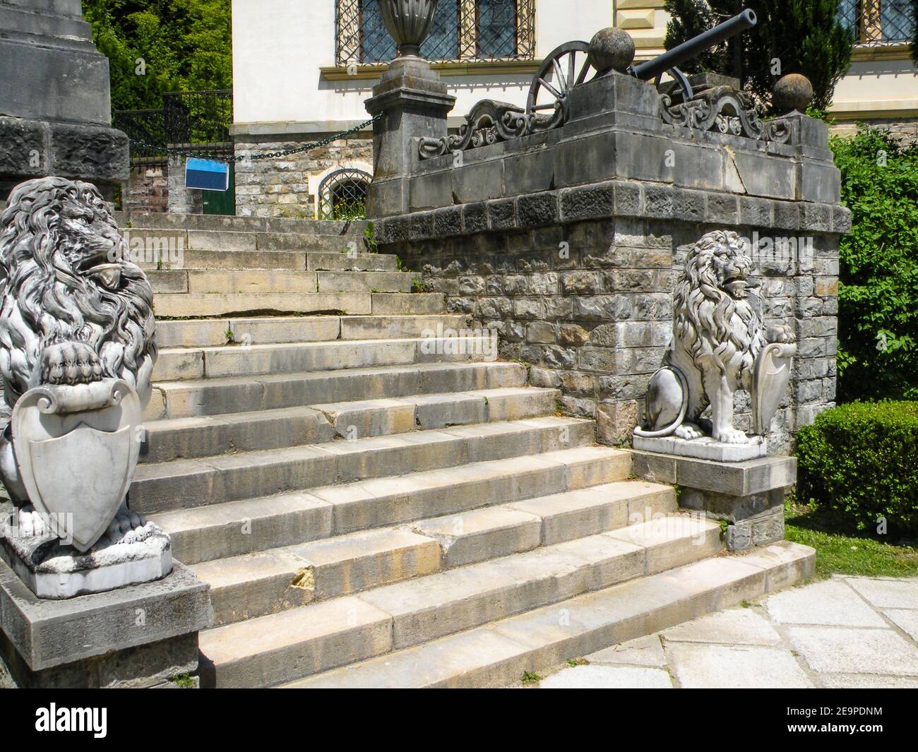 A stone lions sculpture in front of stone steps Stock Photo - Alamy