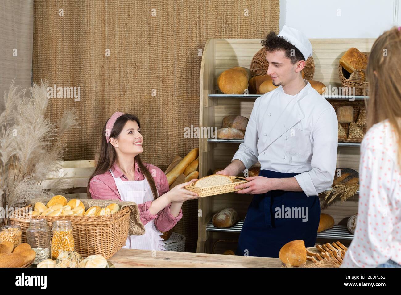 A young couple sells half a loaf of bread to a young teenager in a ...