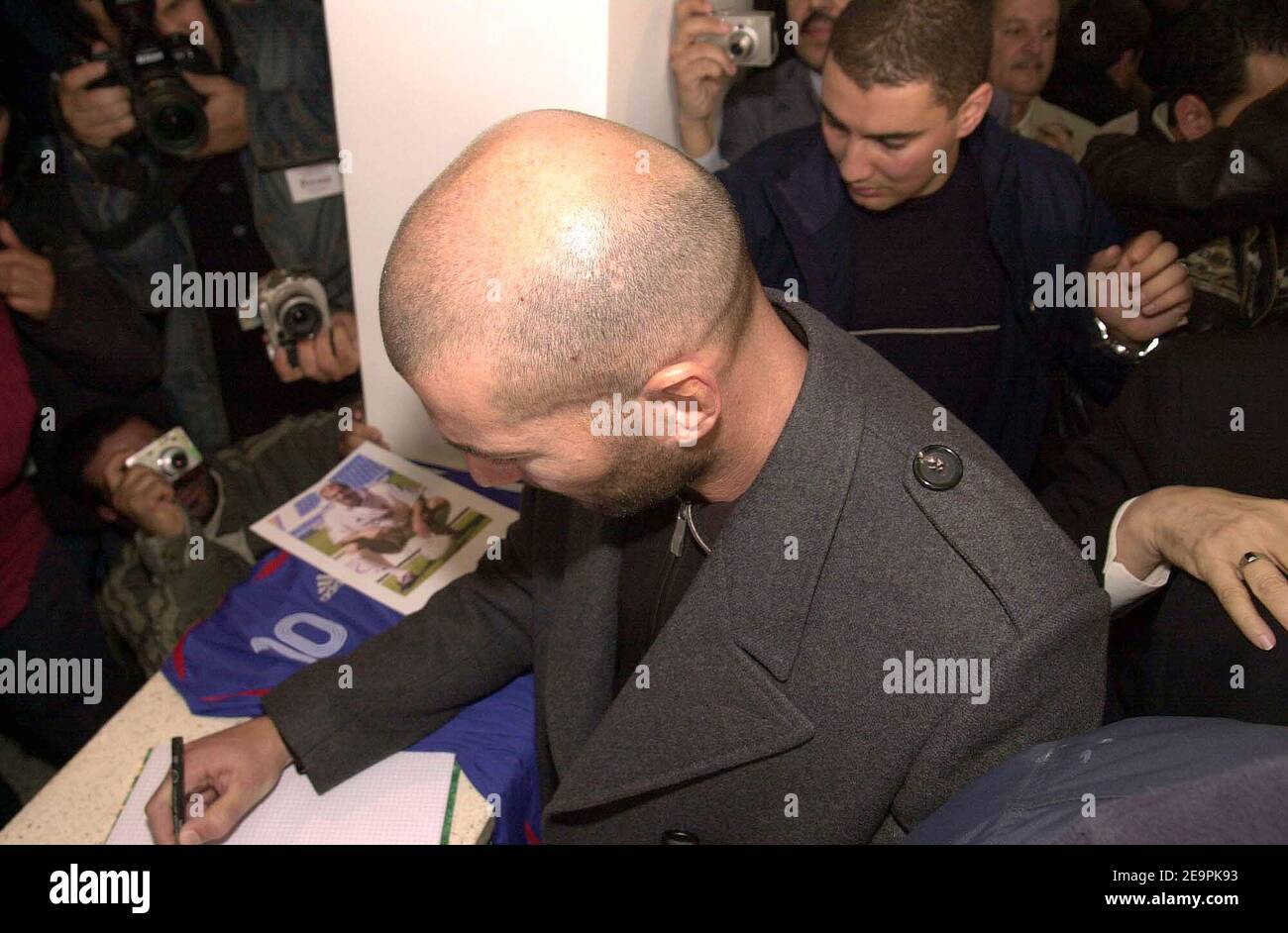 French soccer star Zinedine Zidane signs numerous autographs to his ...