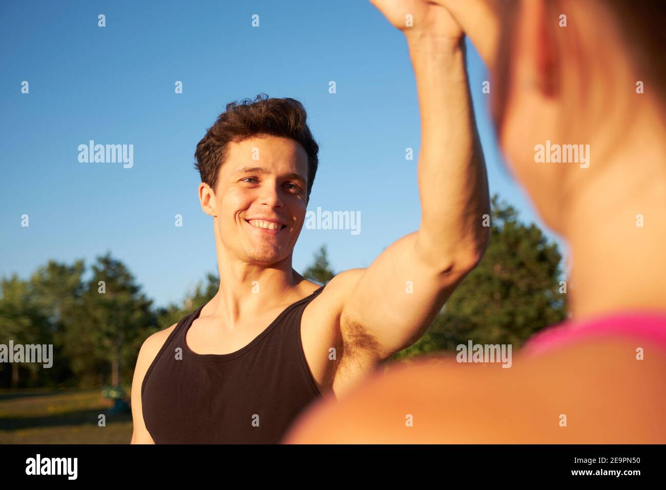 Athletes high fiving eachother during workout in public park, Montreal ...