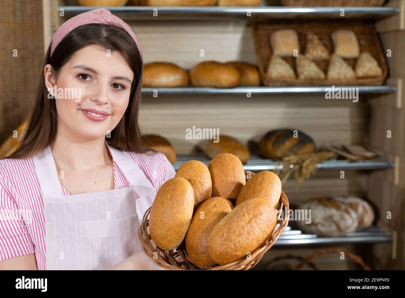 In a traditional bakery, the saleswoman advertises the latest type of ...