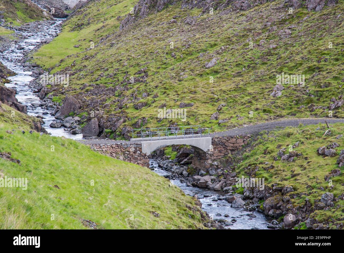 Old rebuilt vintage bridge across river blaskeggsa in Hvalfjordur in ...