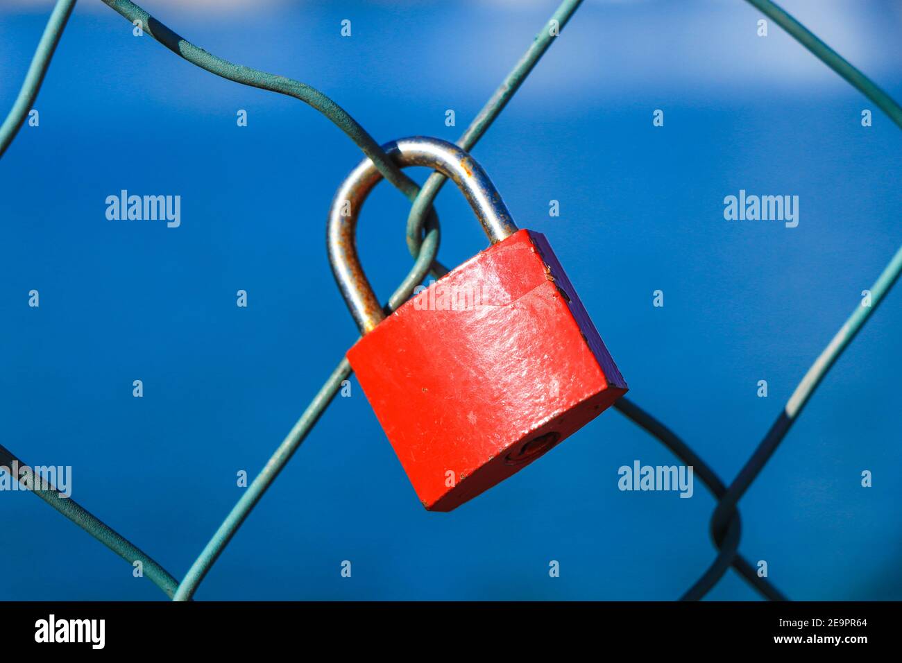 Red padlock in a metal fence Stock Photo - Alamy