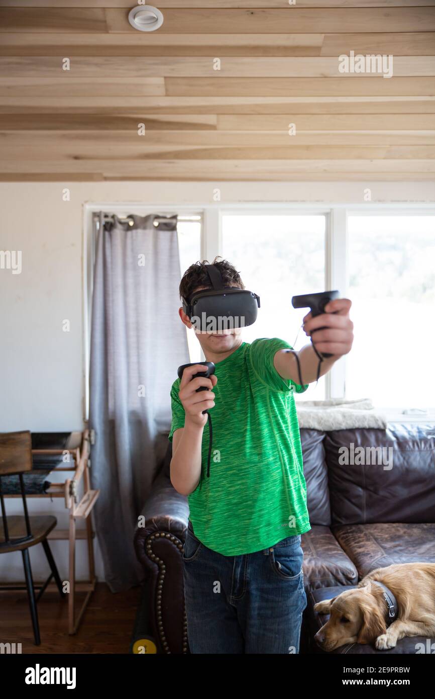 Boy playing video game on virtual reality system Stock Photo - Alamy