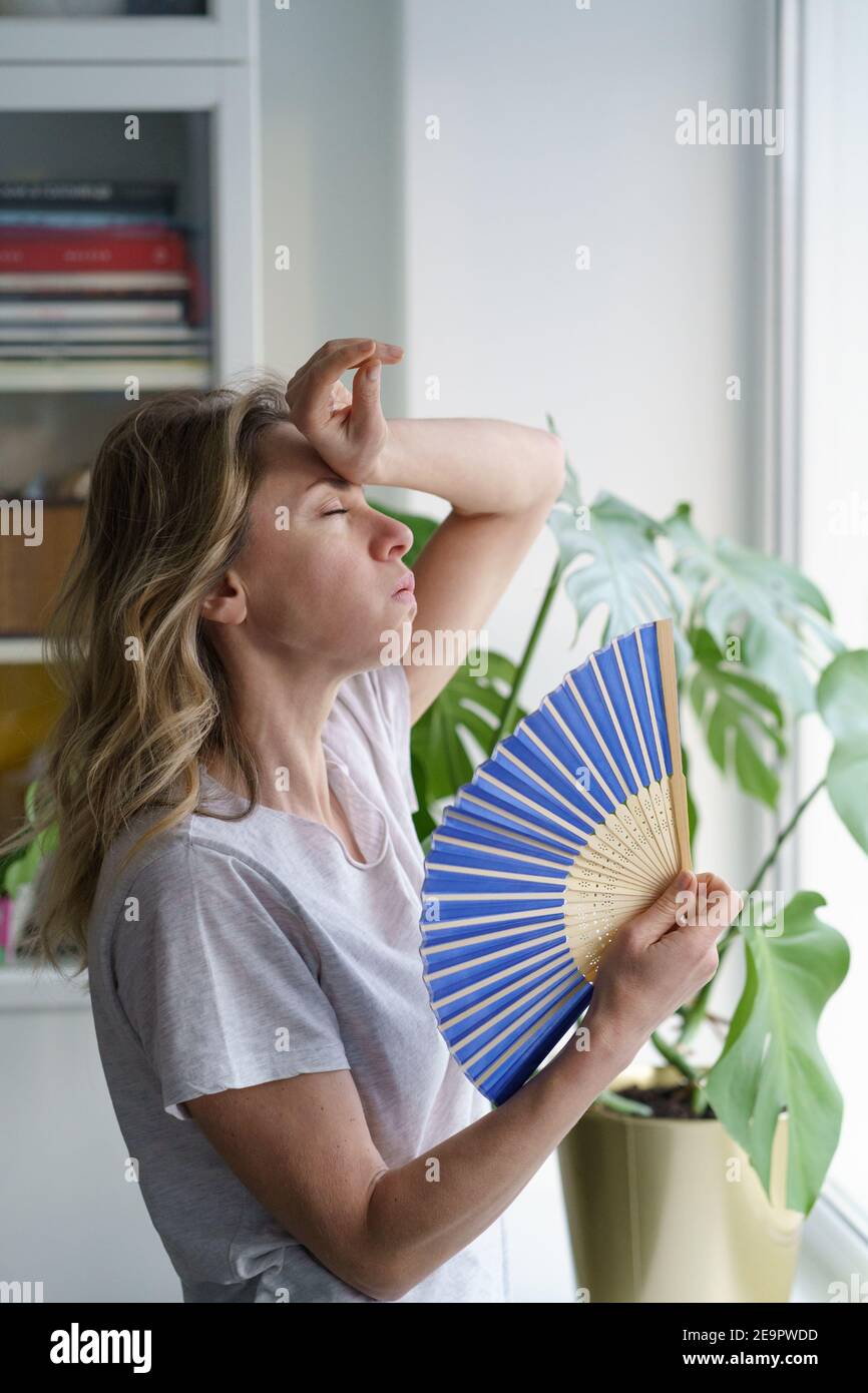 Too hot woman sweating fan hi-res stock photography and images - Alamy