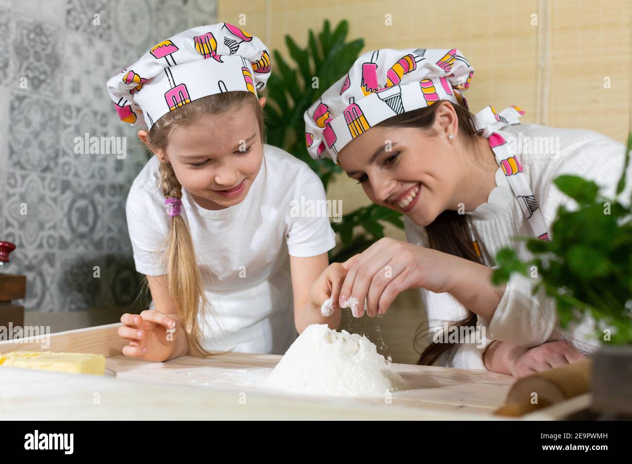The daughter and mother touch the sifted poppy with their fingers and ...