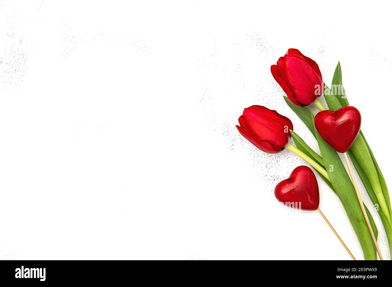 Valentines day background. Red tulip flowers and hearts Stock Photo - Alamy