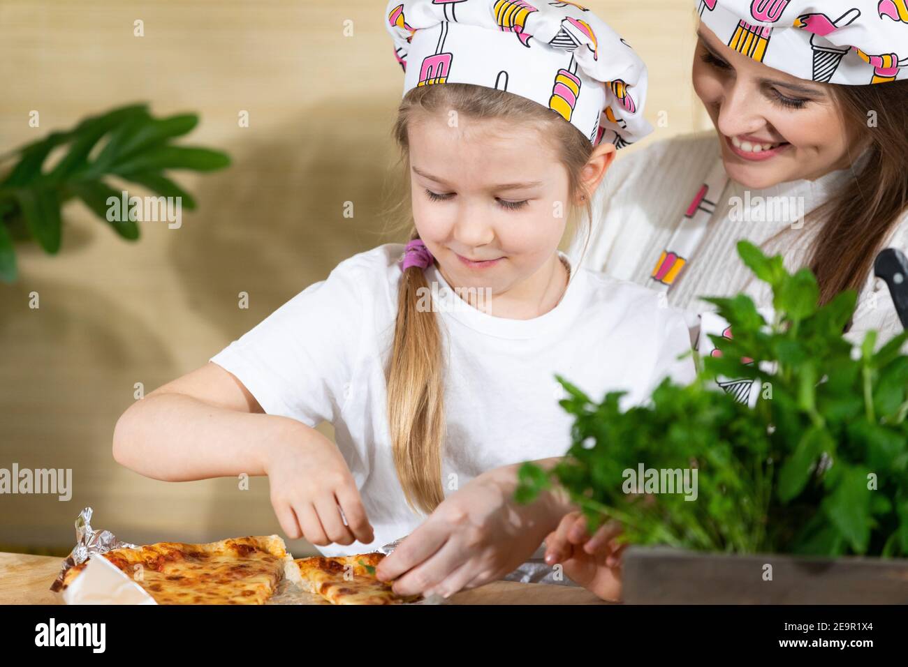 After baking the homemade pizza, the daughter and mother started ...