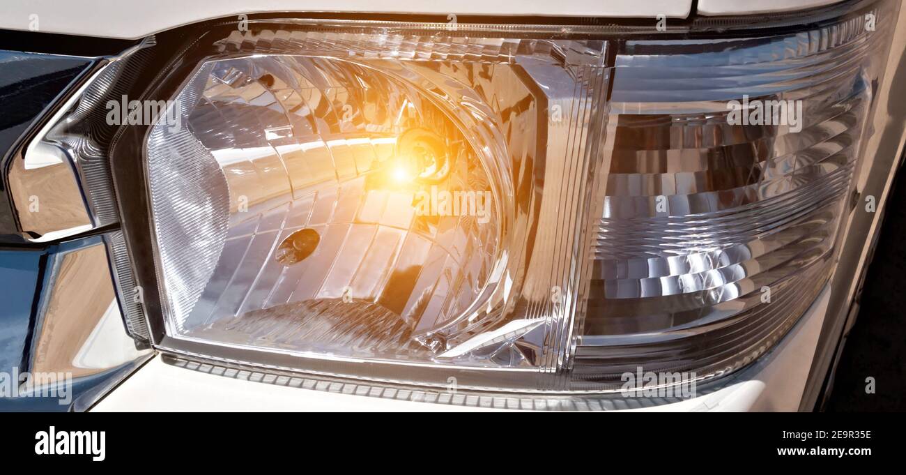 Headlight of a car banner background Stock Photo - Alamy