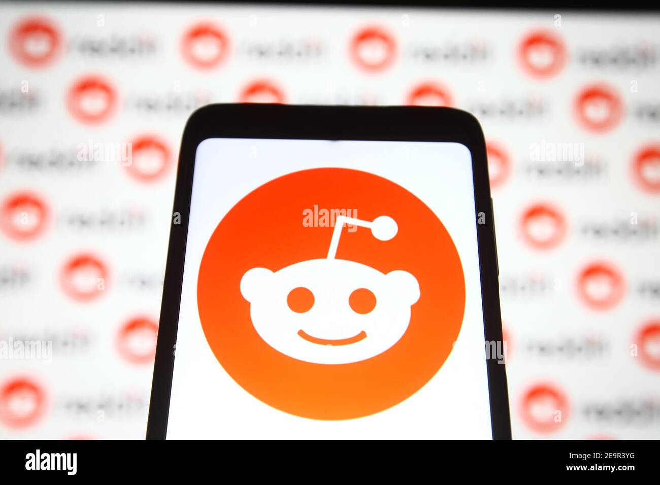 In this photo illustration a Reddit logo is seen on a mobile phone and ...