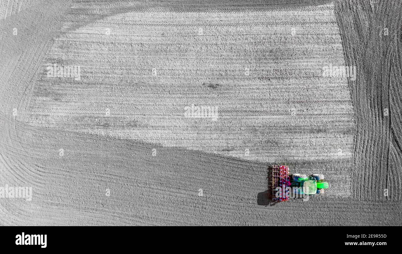 aerial view of a tractor located in the corner of the photo leaving ...