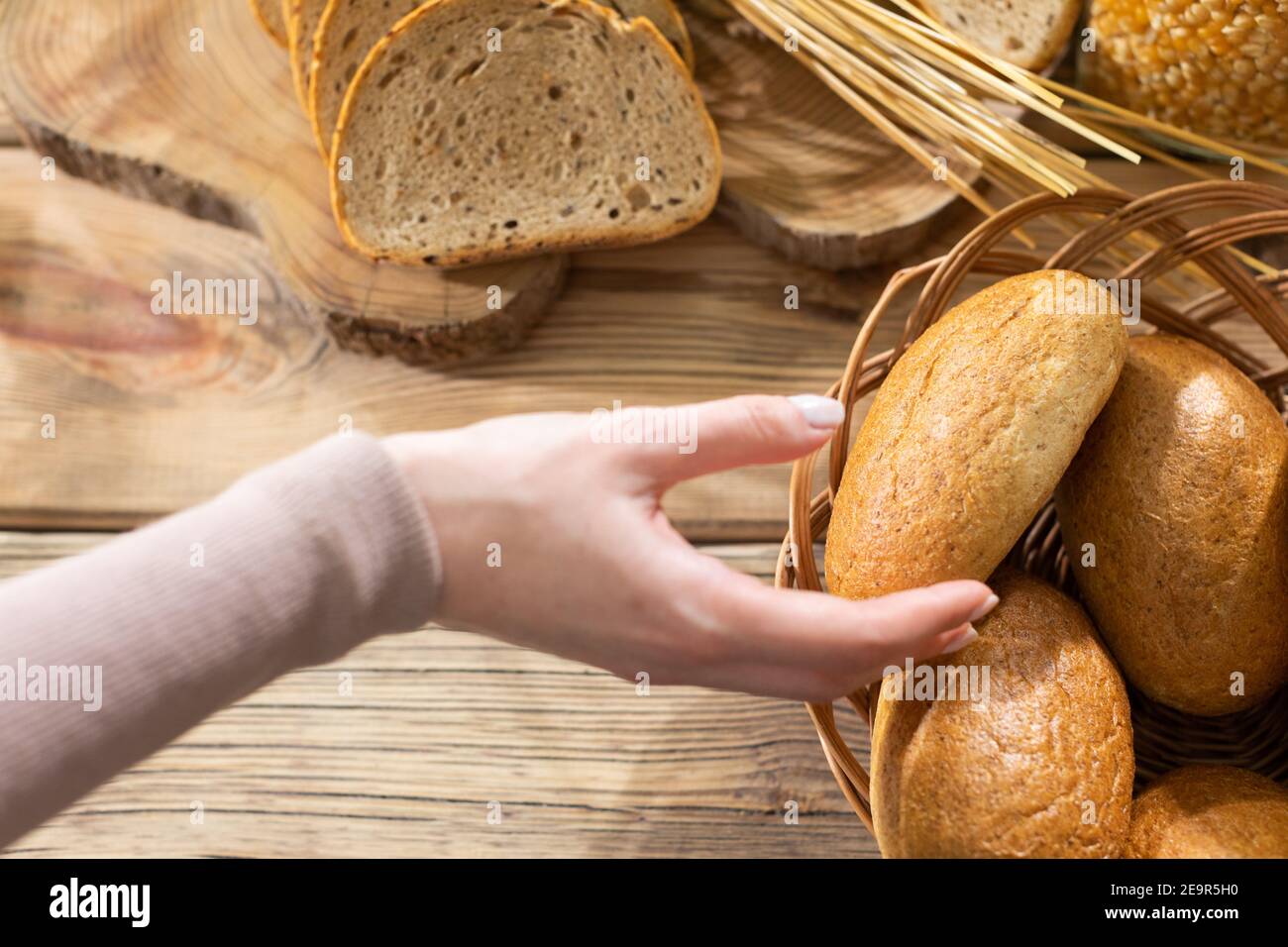 A view from above how a bakery worker gently translates individual buns ...