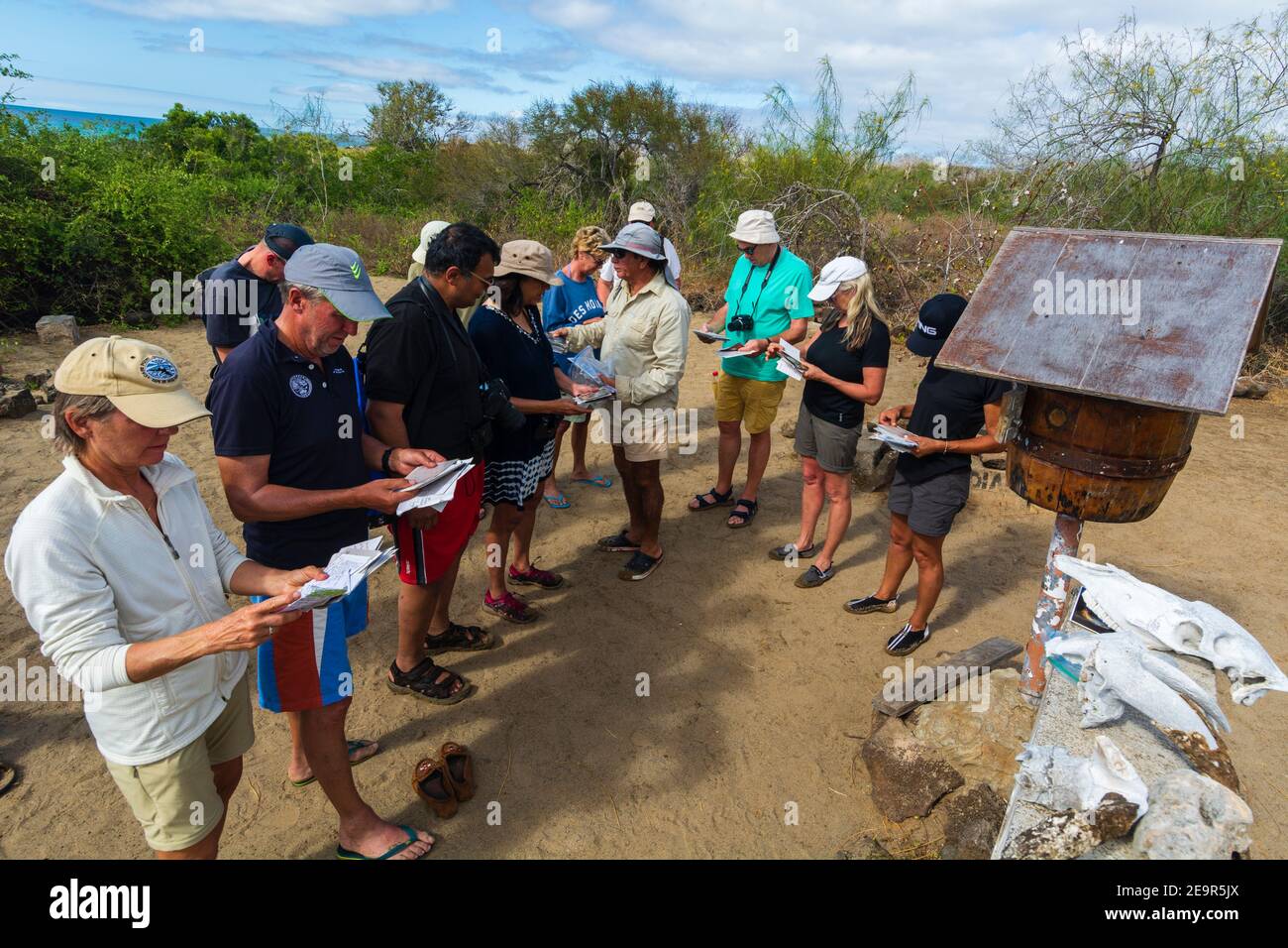 Tourist at the mail box of Post Office Bay, Floreana Island, Galapagos ...