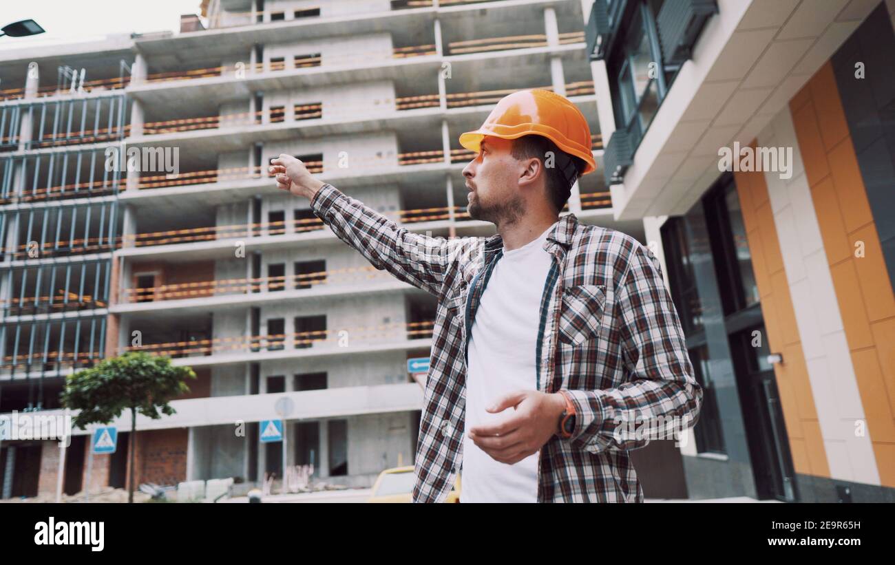 Civil engineer giving instructions to construction workers on ...