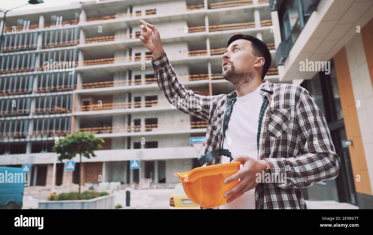 Civil engineer giving instructions to construction workers on ...