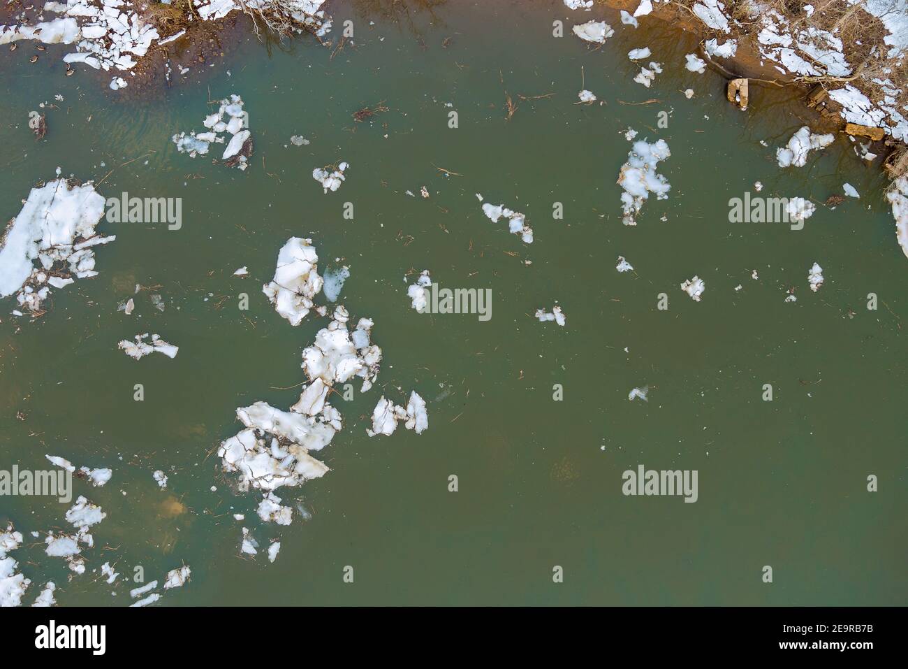 Early spring with broken ice float down the stream small breaking on ...