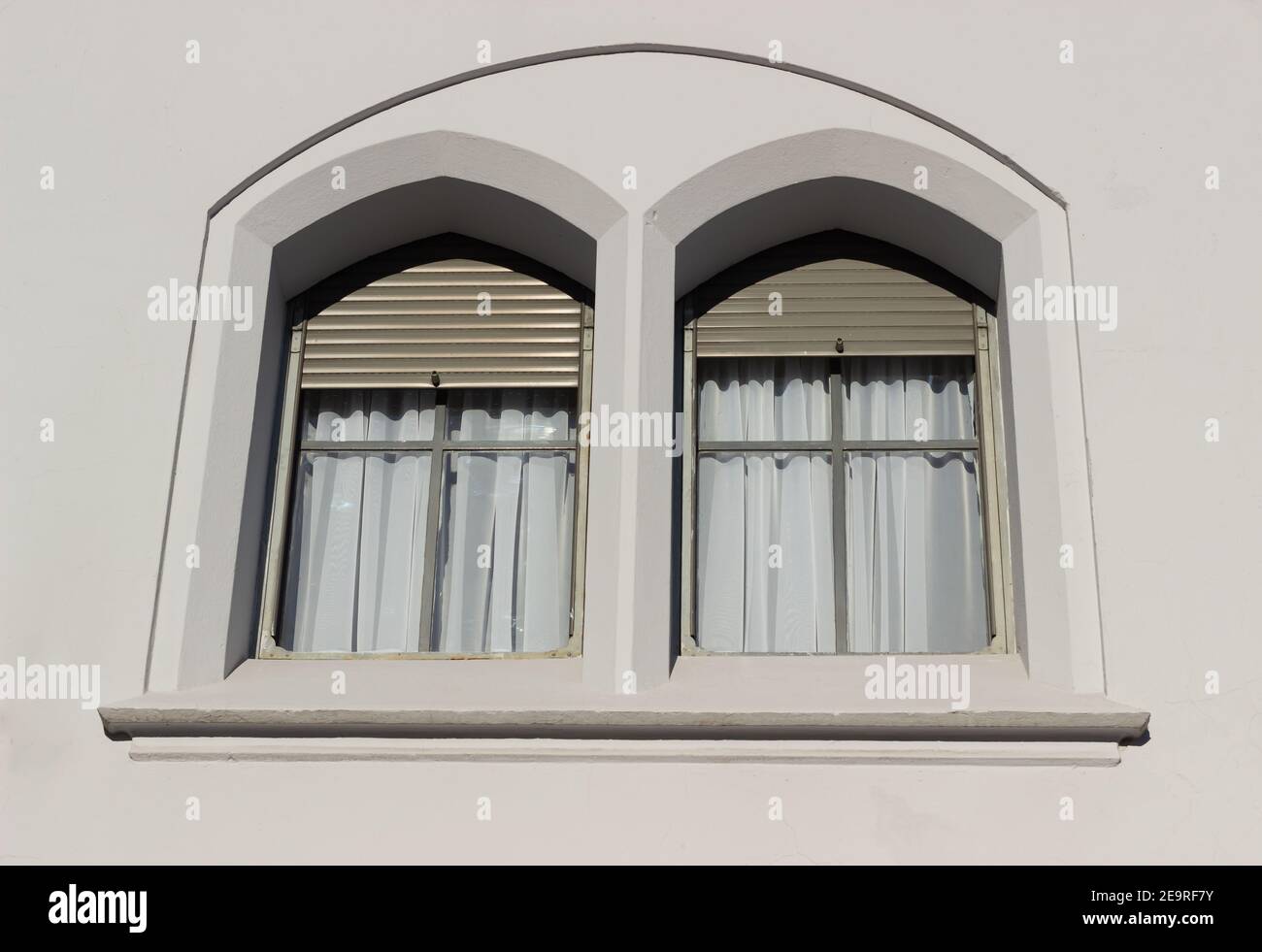 Colonial style windows with white curtains Stock Photo - Alamy